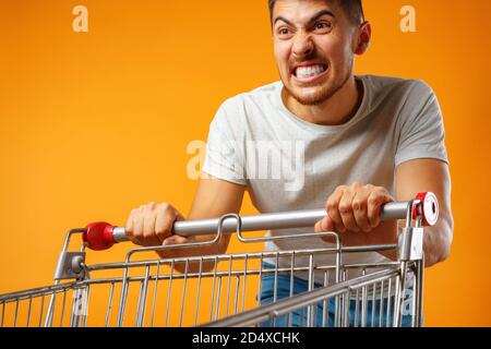 Funny crazy man rushing with shopping trolley to sale Stock Photo - Alamy