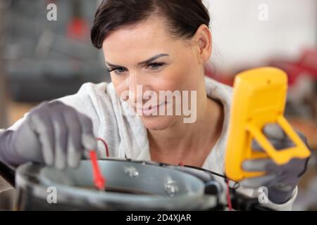 female computer technician using multimeter Stock Photo - Alamy