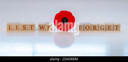 Lest we forget, text on wood blocks with a poppy flower. Concept ...