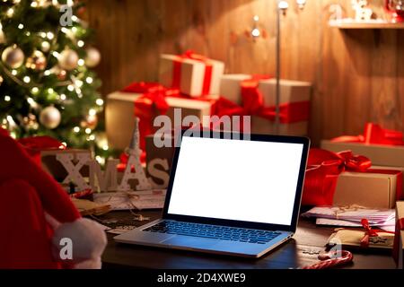 Laptop and Christmas gifts at workplace in office Stock Photo - Alamy