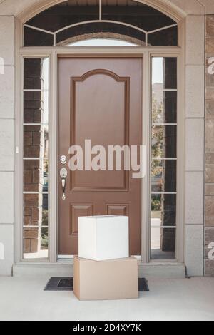Shipping boxes on front porch of home Stock Photo - Alamy