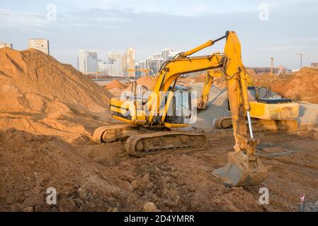 Group of the excavators for dig ground trenching at a construction site ...