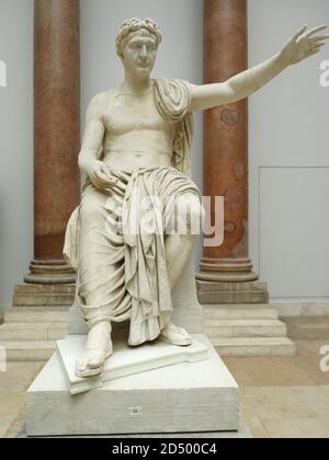 Over life-sized statue of a Roman Emperor sitting on his throne in the ...