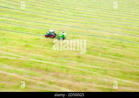 a tractor makes hay from above Stock Photo - Alamy