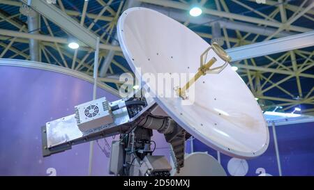 White rotating satellite dish antenna using to receive or transmit information Stock Photo - Alamy