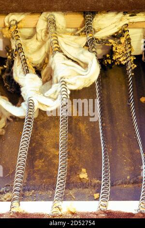 Old chair with broken springs Stock Photo - Alamy