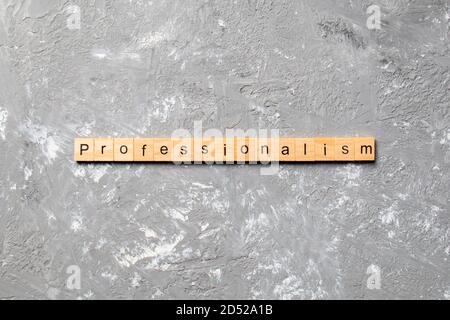 Professionalism word written on wood block. Professionalism text on ...