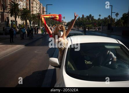 A protester wearing scarf on his face is seen holding a traditional ...