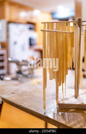 Fresh home made pasta hanging from pasta tree Stock Photo - Alamy
