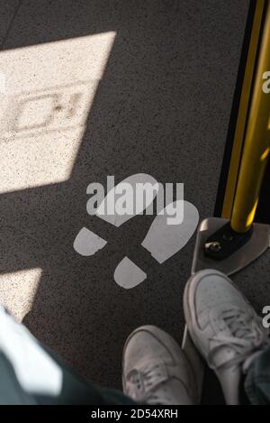 A vertical shot of a person's feet near the Stop here sign Stock Photo ...