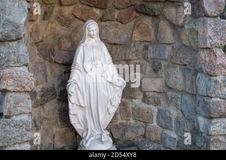 Granite stone Virgin Mary statue on a decorative Catholic headstone at ...