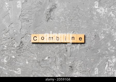 COMBINE word written on wood block. COMBINE text on cement table for ...