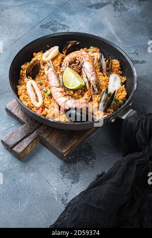 Homemade freshly prepared paella with chicken and seafood on grey ...