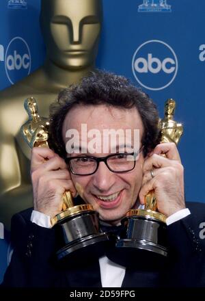 Roberto Benigni with his two oscars which he won at the 71st annual ...