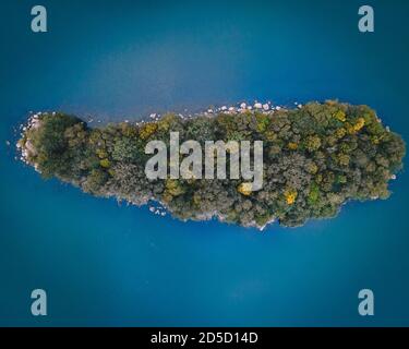 A beautiful shot of a lone tree and a park bench with clouds and bright ...