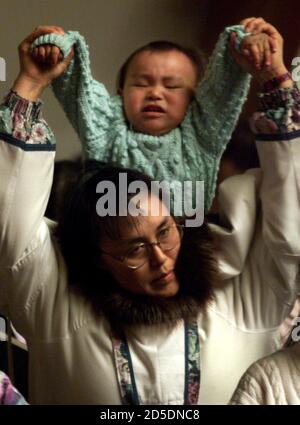 Inuit woman with her baby in traditional Amauti dress in North Americas ...
