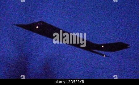 An F-117 Nighthawk stealth fighter in a turn with vapor trails coming ...