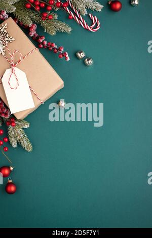 Gift box with Christmas balls and bells on red background Stock Photo ...