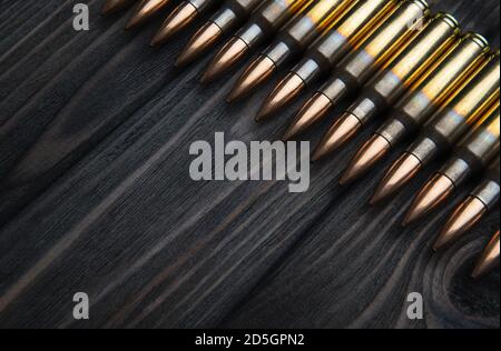 artridges for weapons on a wooden background. Ammunition on a vintage ...