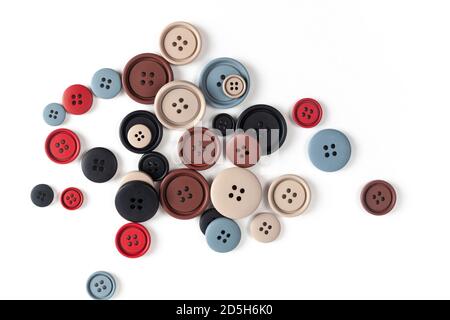 Pile of color plastic matte buttons on white, beautiful needlework ...