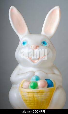 Kids with eggs basket and bunny ears on Easter egg hunt in sunny spring ...