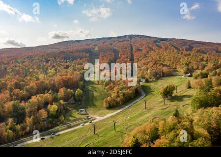 aerial of image of Okemo Mountain in the Fall and a lone fire tower ...