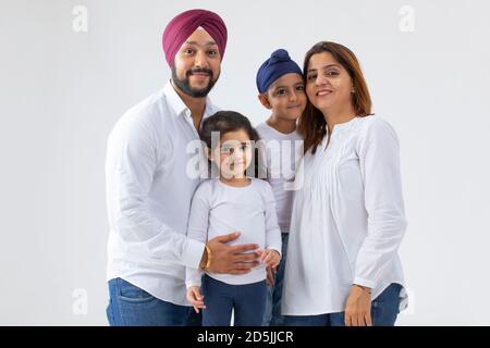 A SIKH FATHER AND SON HAPPILY STANDING TOGETHER AND LOOKING AT CAMERA ...