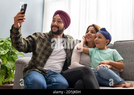 A HAPPY SIKH FAMILY POSING TOGETHER Stock Photo - Alamy