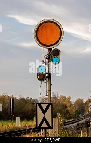 Historic train signal lights with railway line with old train and ...