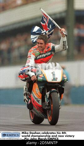 Mike Doohan celebrates winning the race and his fourth world ...