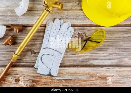 Copper water pipes on wooden board Stock Photo - Alamy