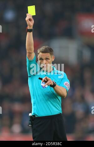 Referee Craig Pawson produces a yellow card Stock Photo - Alamy