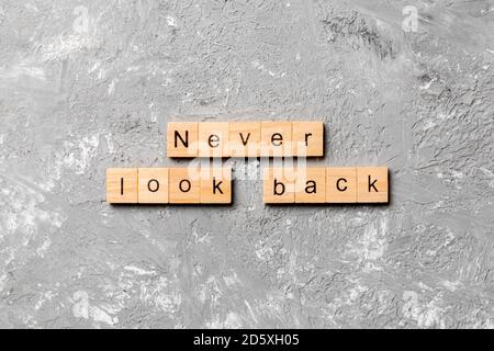 never look back word written on wood block. never look back text on ...