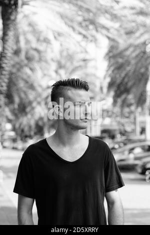 Pensive black man standing outside in city downtown. Thoughtful African ...