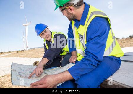 Engineers looking at map Stock Photo - Alamy