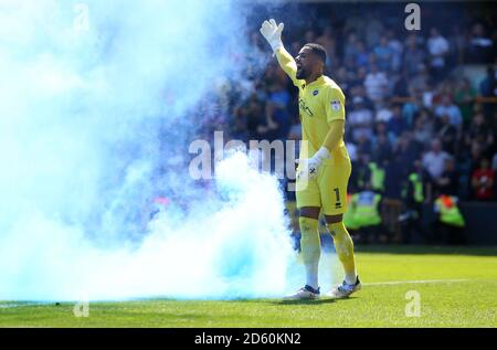 Millwall goalkeeper Jordan Archer is engulfed by a smoke bomb thrown ...