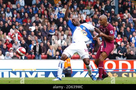 (L-R) Blackburn Rovers' Jason Roberts has his shirt pulled by Bolton ...