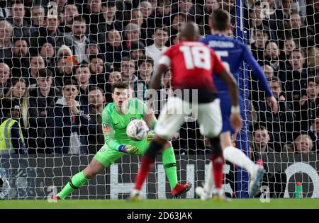 Chelsea goalkeeper Kepa Arrizabalaga makes a save with his legs during ...