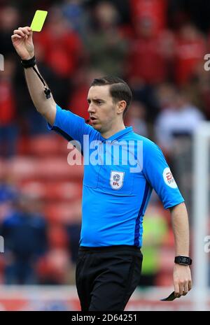 Referee, Ben Toner shows a yellow card to Harrison Neal of Carlisle ...