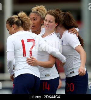 England's Emily Syme celebrates with her team mates after she scores to ...
