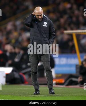 A dejected Pep Guardiola manager of Manchester City walks over to the ...