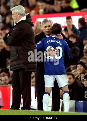 Everton manager Carlo Ancelotti embraces with his players during the ...