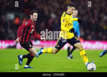 Bournemouth's Adam Smith (left) and Arsenal's Gabriel Martinelli battle ...