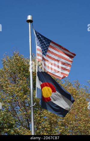 American and Colorado Flag waving in the wind with Pikes Peak and Stock ...
