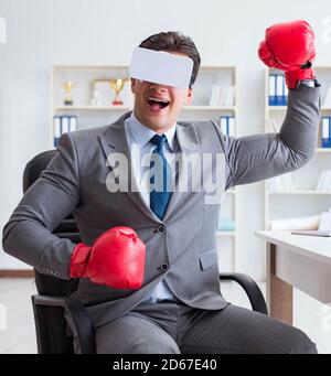 Man boxing in the office with virtual reality goggles Stock Photo - Alamy