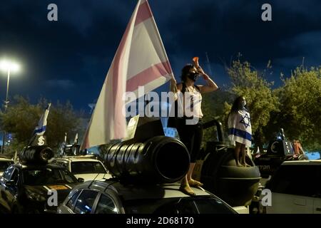 An Israeli flag waves on the top of a destroyed building in southern ...