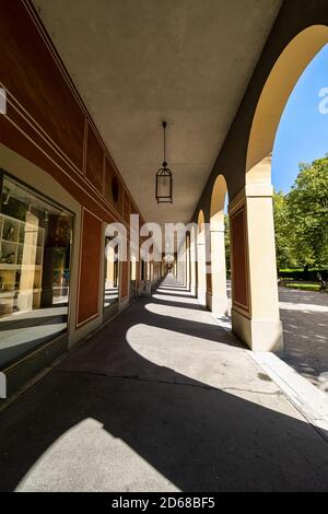 Promenade with long arcade columns surrounding Hofgarten Park in Munich ...