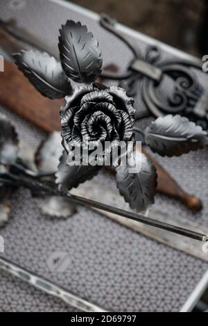 Metal rose made by a blacksmith over gray background Stock Photo - Alamy