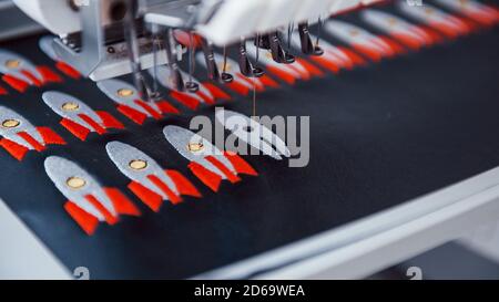 Making rocket pictures. Close up view of white automatic sewing machine ...
