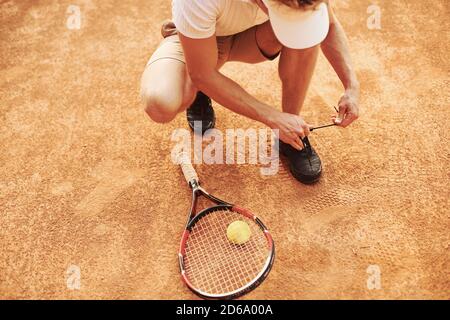 Getting prepared. Young tennis player in sportive clothes is on the ...